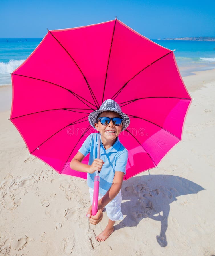 Boy with a Pink Umbrella on the Sandy Beach Stock Photo - Image of ...