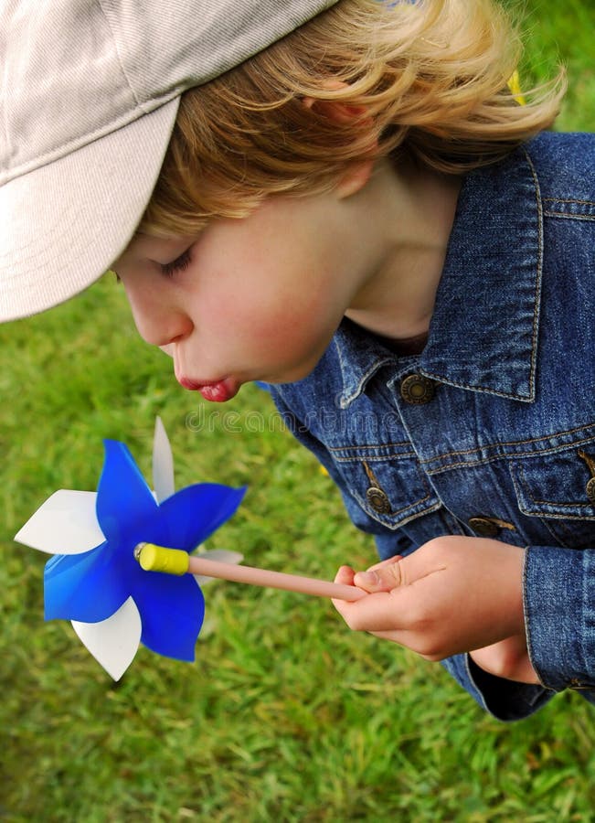 Boy and pinwheel stock image. Image of blowing, foil, mouth - 2664467