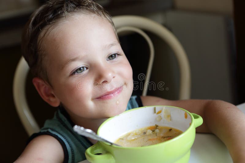 Boy with plate of soup stock photo. Image of dining, meal - 57497354