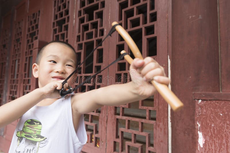 Boy play catapult stock photo. Image of china, hand, skill - 57823282