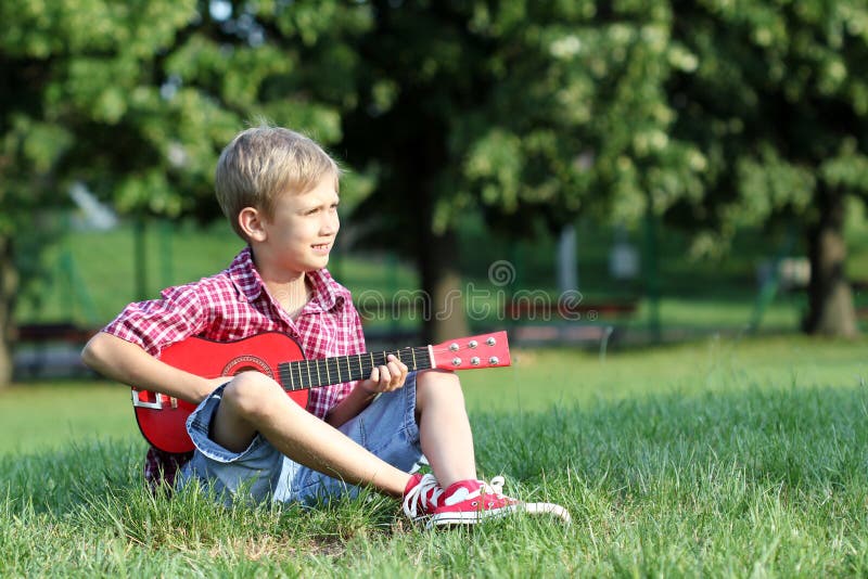 Boy play guitar stock photo. Image of melody, green, music - 34439470