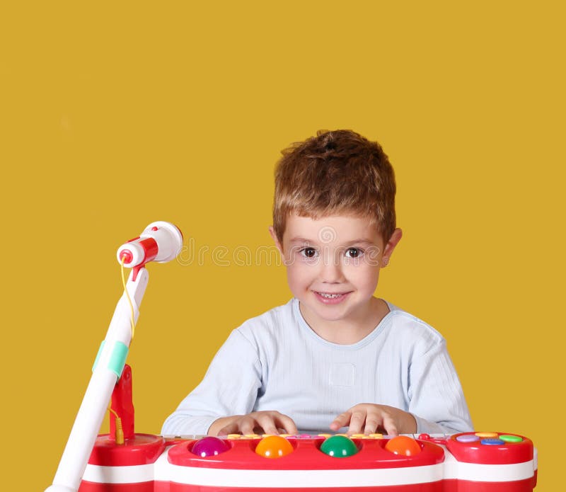 Boy play music on keyboard stock photo. Image of player - 33834522