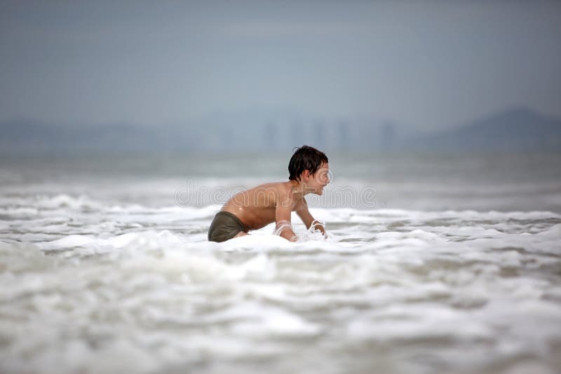 Boy in waves in ocean stock image. Image of nature, ocean - 34814001