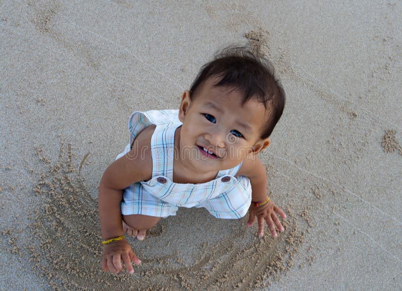Boy play sand on the beach stock photo. Image of cute - 98587166