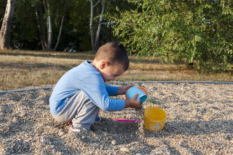 Little Boy Writing On The Ground Stock Image - Image of exploring ...