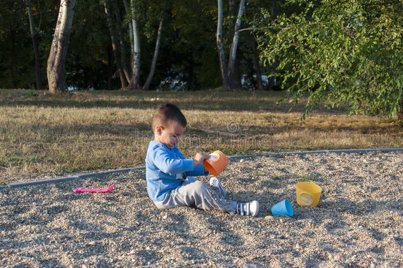 Boy play in the sand stock photo. Image of ground, childhood - 33882628
