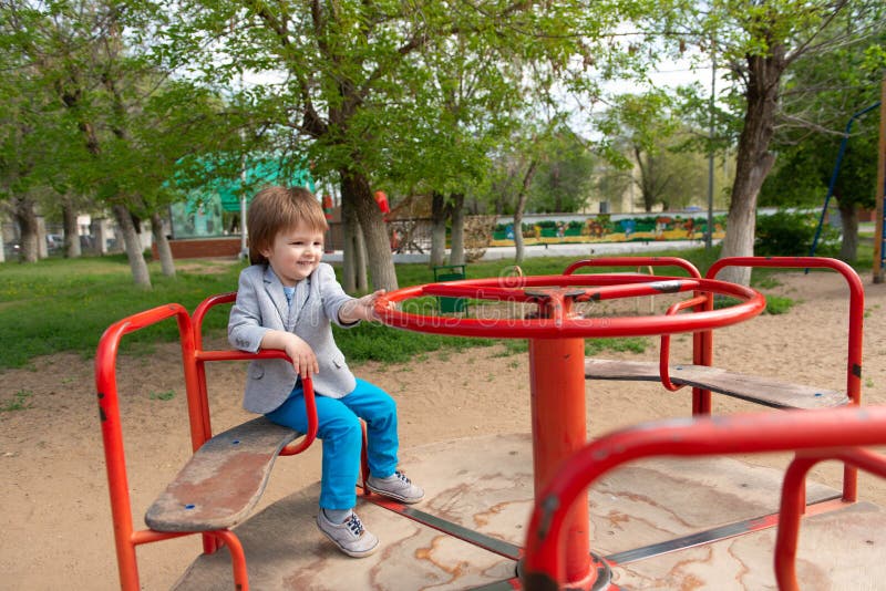 Boy on the Playground Rides on a Swing Stock Photo - Image of kids ...