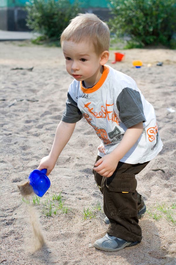 Boy playing stock image. Image of sand, pile, looking - 5681799