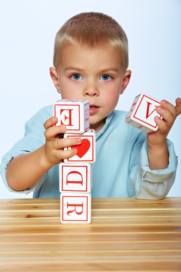 Boy Playing with Alphabet Blocks Stock Photo - Image of natural, eyes ...