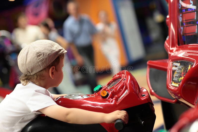 Boy Playing Arcade Simulator Machine Stock Photo - Image of little ...