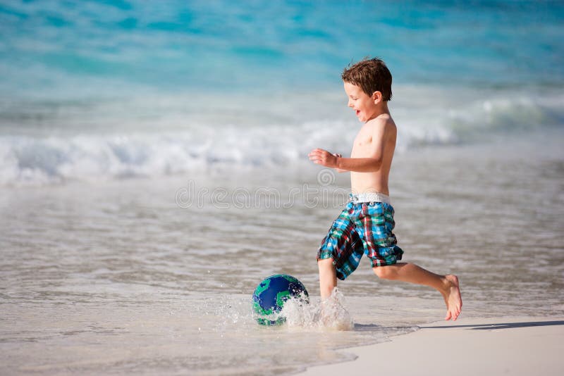 Boy Playing with Ball on Beach Stock Photo - Image of cheerful ...