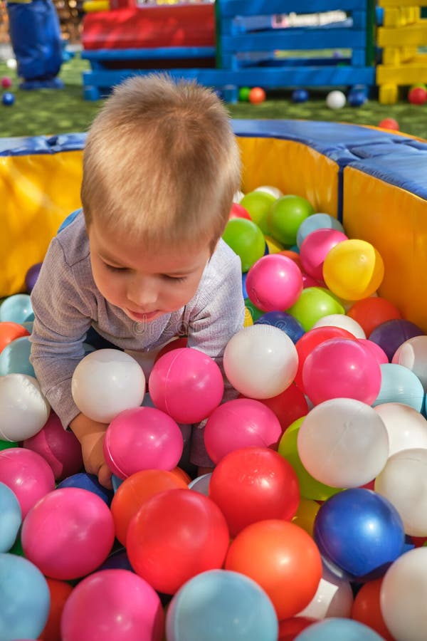 Boy is Playing in the Ball Pool at Children`s Playground Stock Photo ...