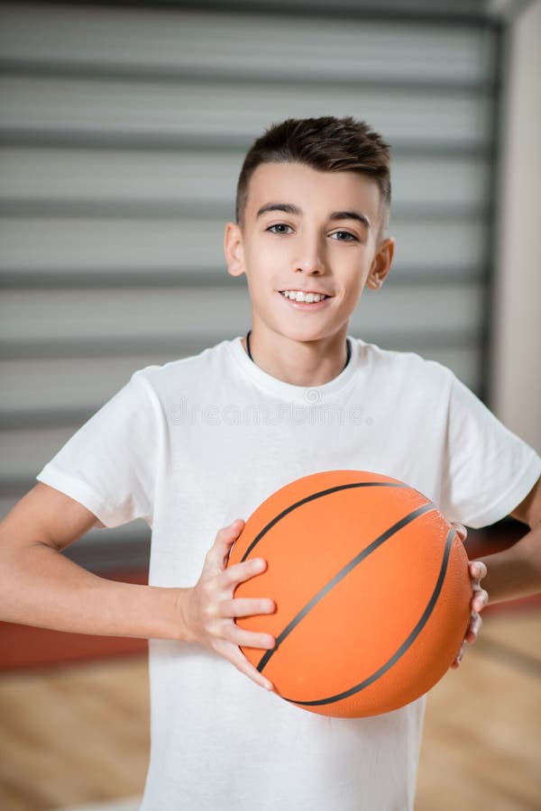 A Boy Playing Basketball in the Gym and Looking Involved Stock Image ...