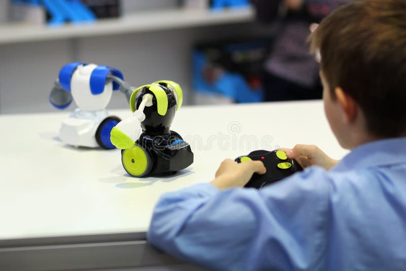 Boy Playing Battle Fighting Robots with Remote Control. Robotics Stock ...