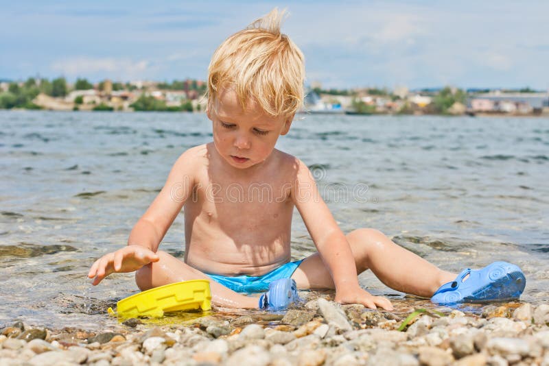 Boy playing on the beach stock image. Image of curiosity - 20624759