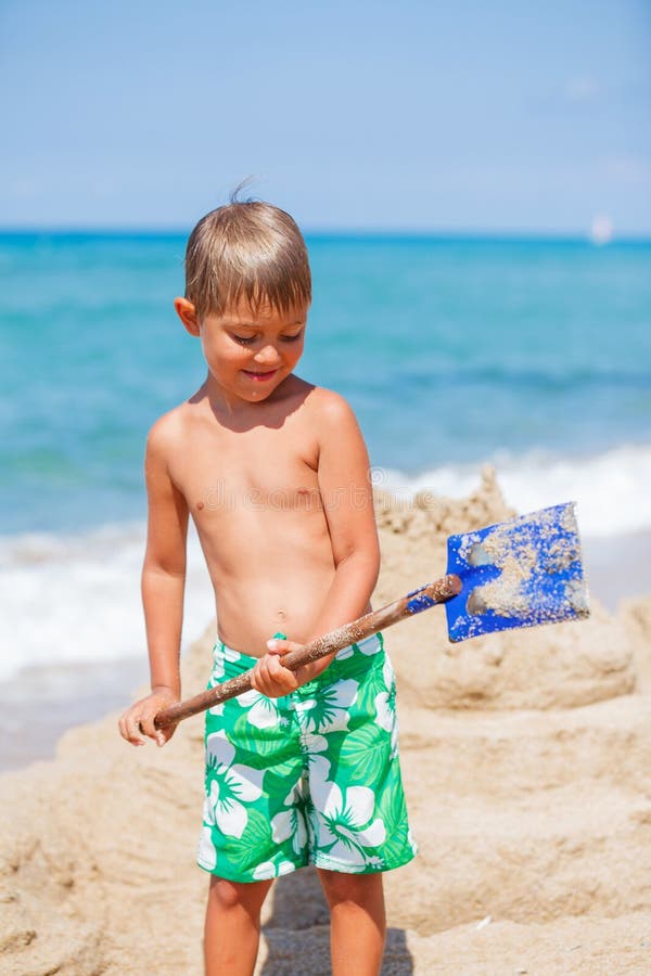 Boy playing on the beach stock photo. Image of enjoy - 51373596