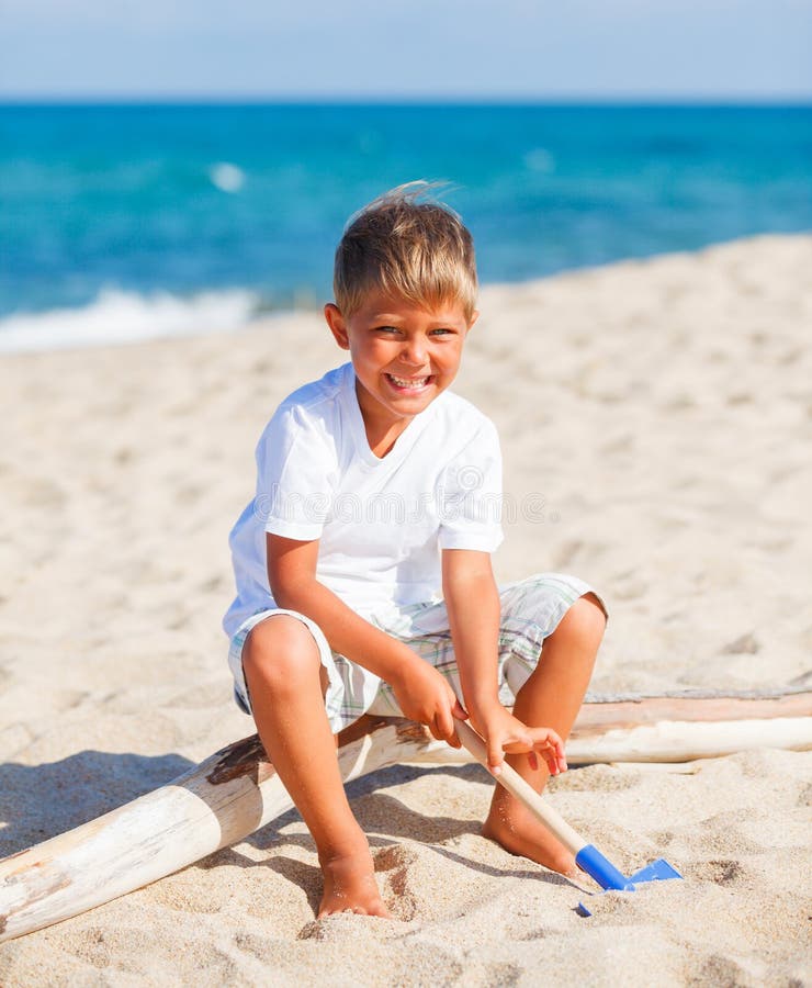 Boy playing on the beach stock photo. Image of childhood - 54090572