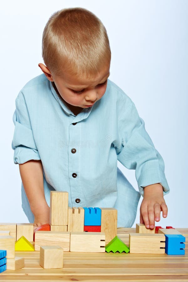 Boy playing with blocks stock image. Image of child, table - 25136805
