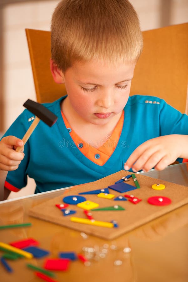 Boy Playing with Blocks and Nails on a Table in Kitchen Stock Photo ...