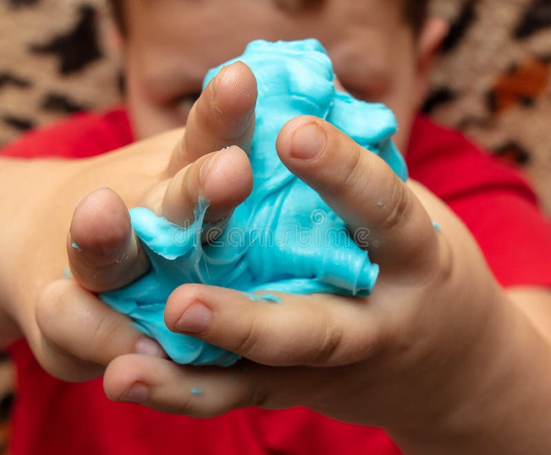 The Boy is Playing with a Blue Slime Stock Photo - Image of foot ...