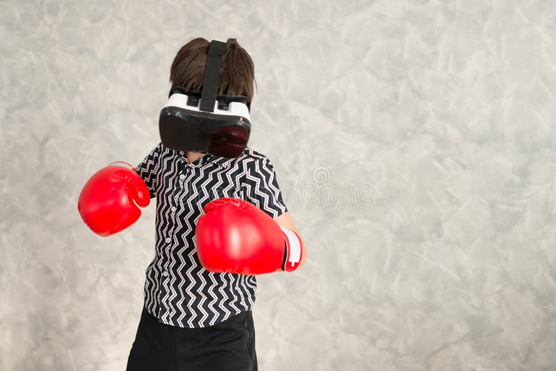 A Boy is Playing Boxing Game with 3D Virtual Reality Headset. Stock ...