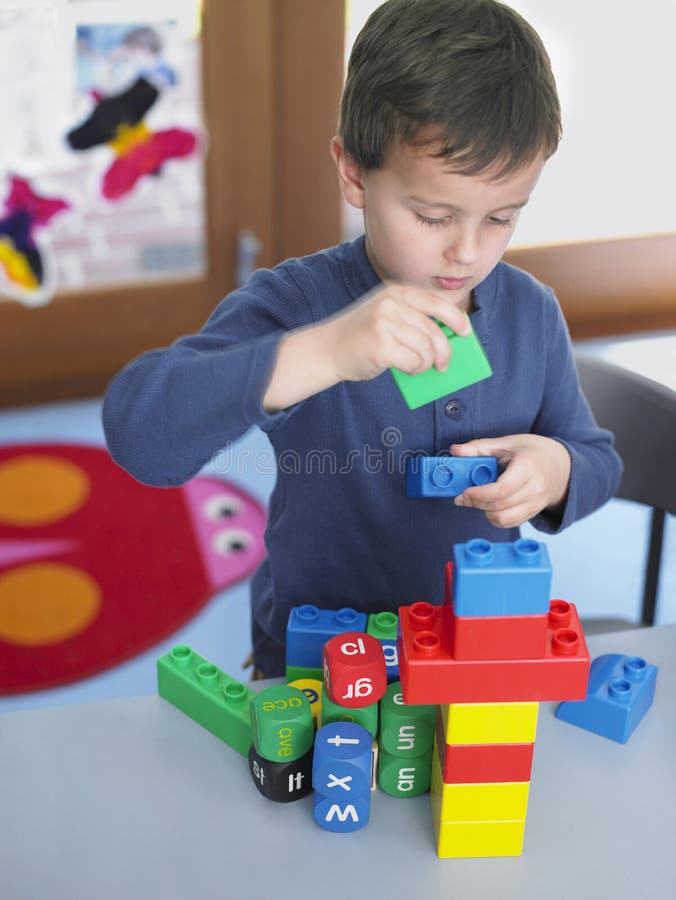 Boy Playing with Building Blocks in Class Stock Photo - Image of ...