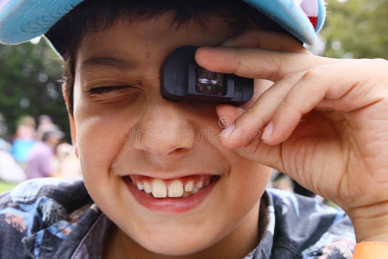 Boy Playing with Camera Eye Piece Stock Photo - Image of teeth, smiling ...