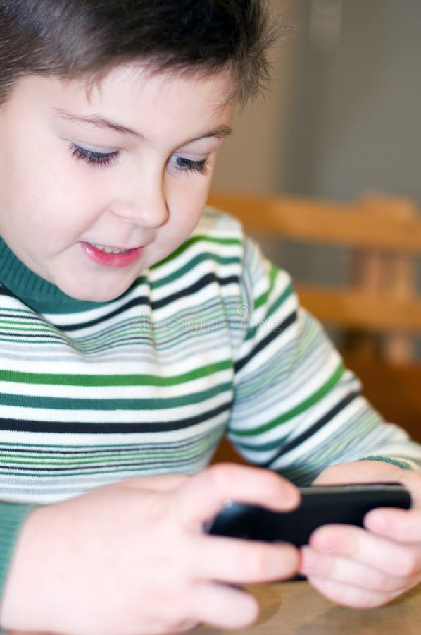 Boy playing on cell phone stock photo. Image of home - 27852738