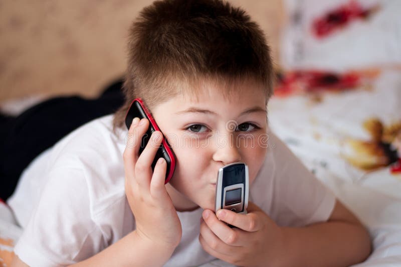 Boy playing on cell phones stock photo. Image of call - 27686224