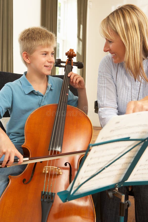Boy Playing Cello in Music Lesson Stock Image - Image of teacher, pupil ...