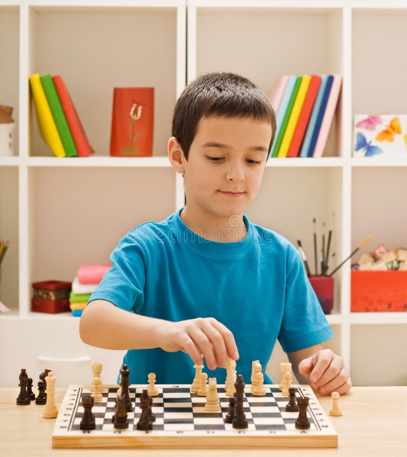 A boy playing chess stock photo. Image of playing, looking - 15359584