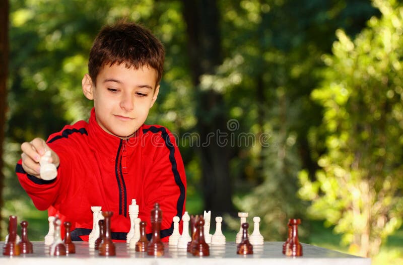 Boy playing chess game stock photo. Image of playing - 26467840