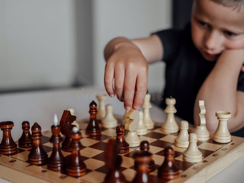 The Boy Playing Chess in the Room. Chess Board in the Foreground Stock ...