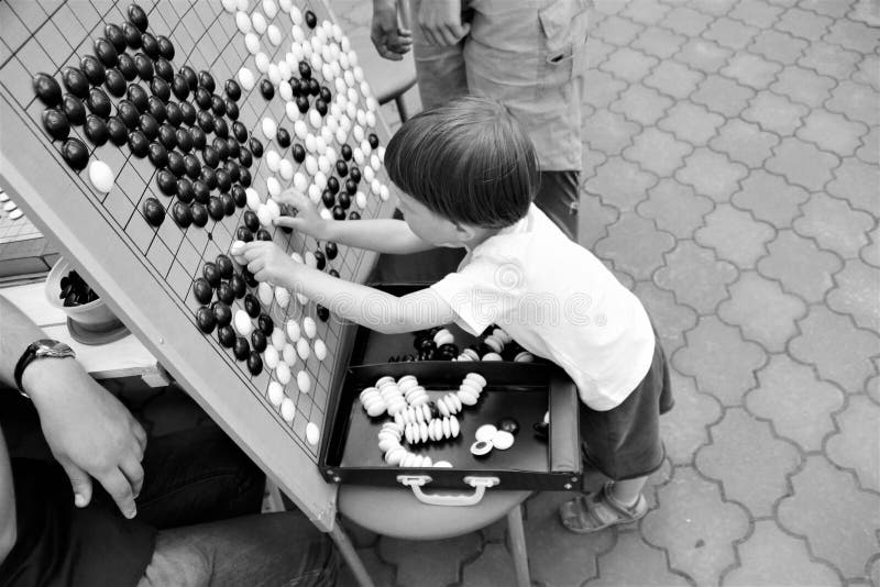 Chinese Go Game on table stock photo. Image of black - 228924396