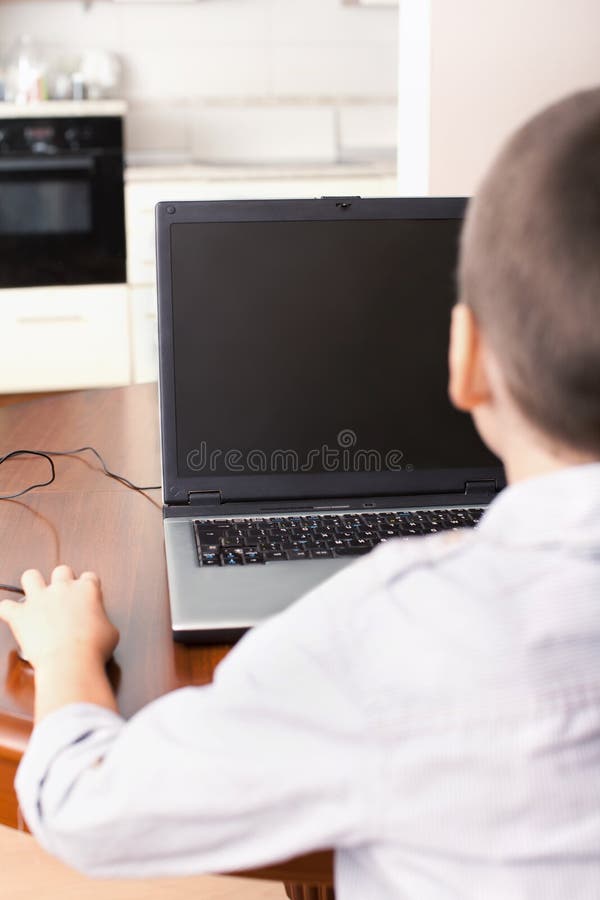 Boy playing a computer stock image. Image of laptop, shoulders - 18717611