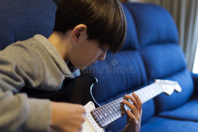 Boy Playing Electric Guitar Stock Image - Image of young, guitar: 237725495