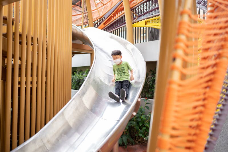 A Boy is Playing with Face Masks on Playground during Quarantine Covid ...