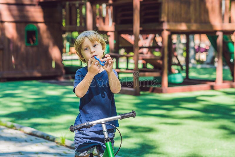 Boy Playing with Fidget Spinner. Child Spinning Spinner on the ...