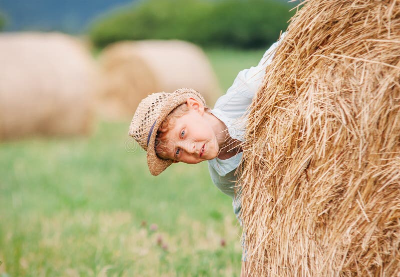 Boy Playing on the Field with Hay Rolls Stock Image - Image of haying ...