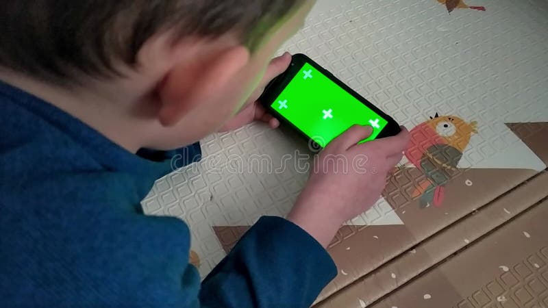 Boy Playing the Game on Smartphone with Green Screen Stock Video ...