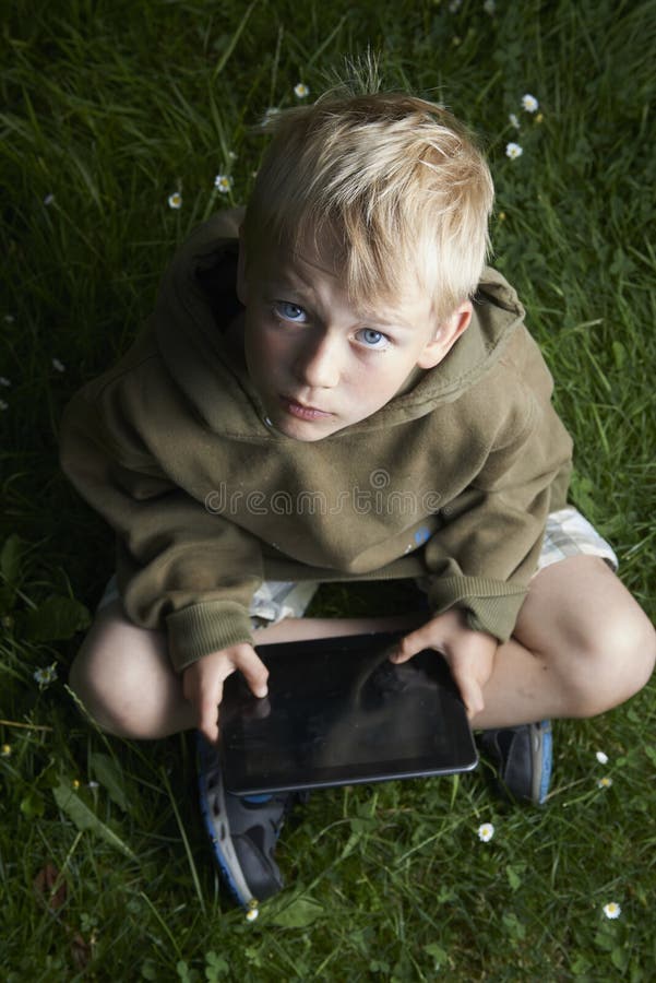 Boy Playing Game with Tablet Pc Outdoors Stock Photo - Image of ...