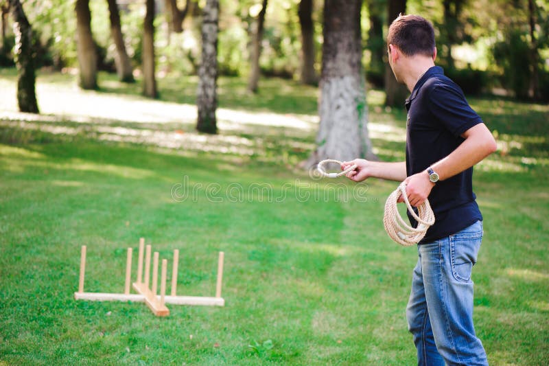 Boy Playing a Game Throwing Rings Outdoors in Summer Park. Stock Photo ...
