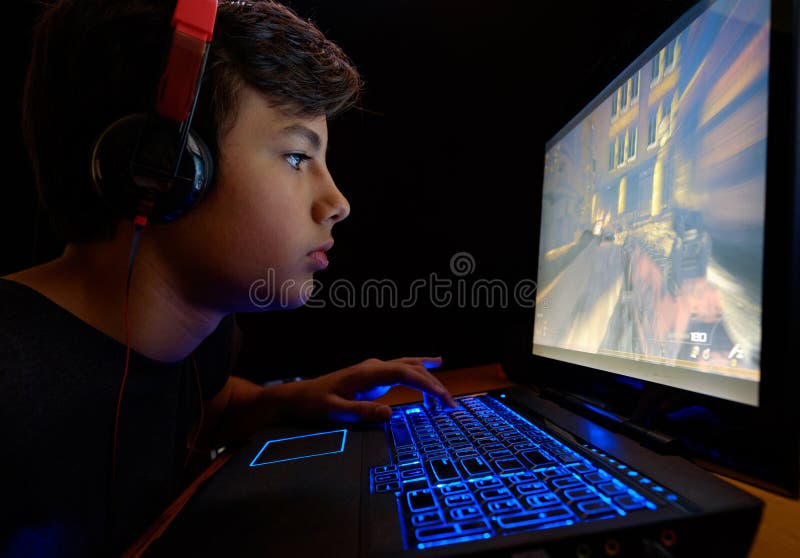 Boy Playing Games on His Laptop Stock Photo - Image of multi ...