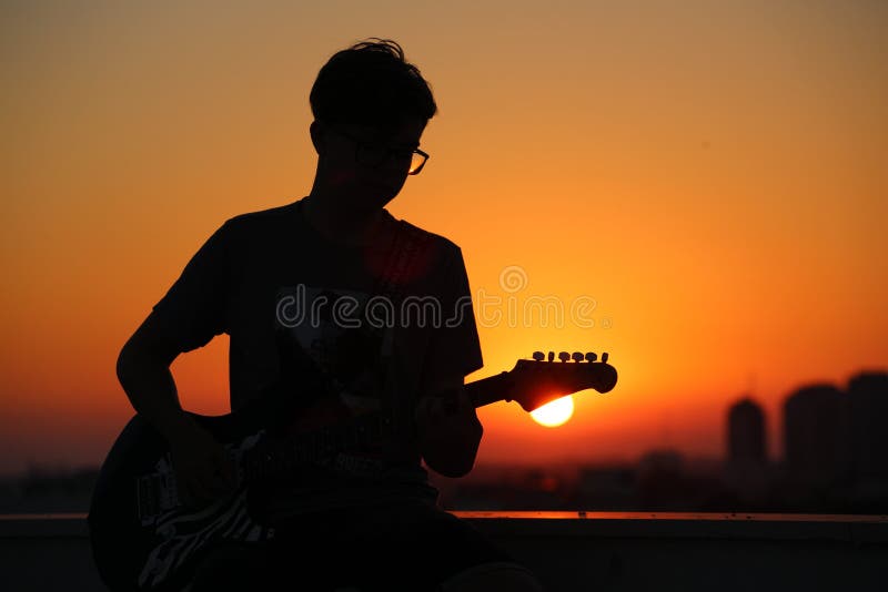 Boy playing guitar stock image. Image of performance - 232906009