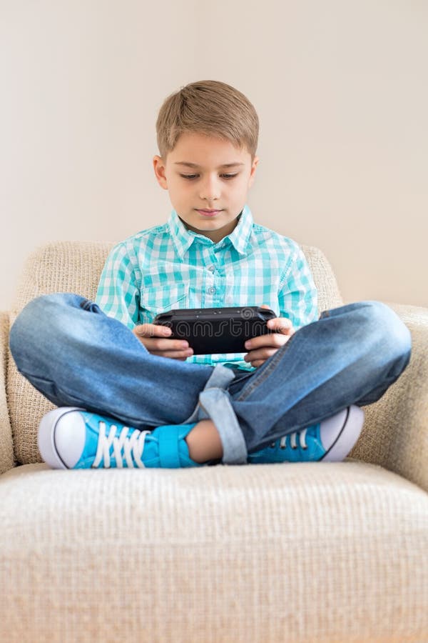 Boy Playing Hand Held Video Game Sofa Stock Photos - Free & Royalty ...