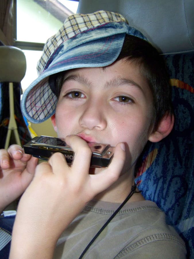 Boy in Checkered Cap Playing the Harmonica Stock Image - Image of ...