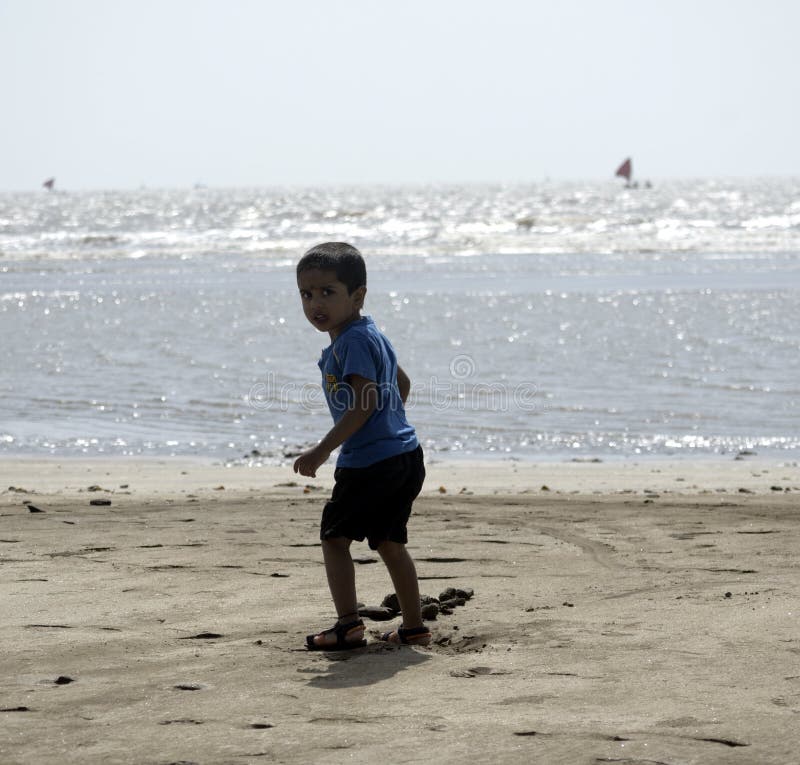Boy playing on beach sand stock photo. Image of lifestyle - 142309060