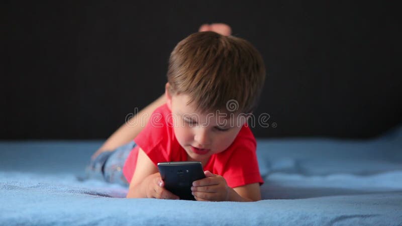 Boy Playing on a Mobile Phone Stock Video - Video of happy, computer ...