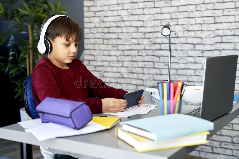 Boy Playing on the Mobile Phone during Online Classes Stock Image ...