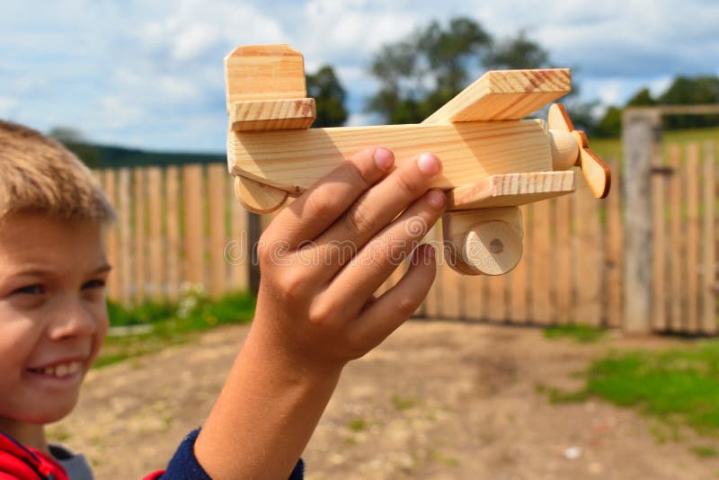 A Boy is Playing with a Model of a Wooden Plane Stock Image - Image of ...